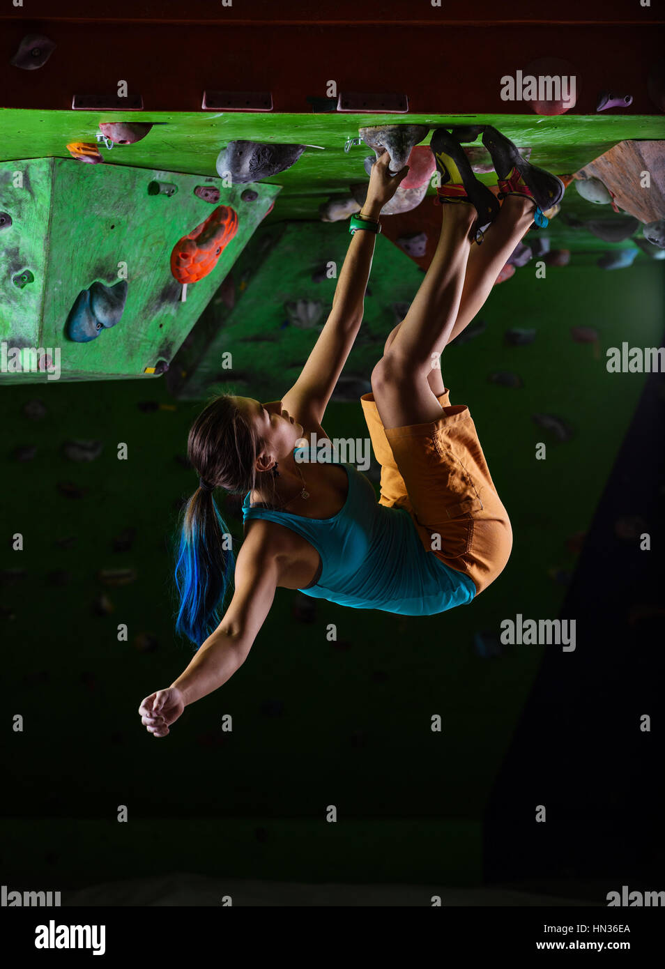 Woman bouldering on climbing gym Stock Photo - Alamy