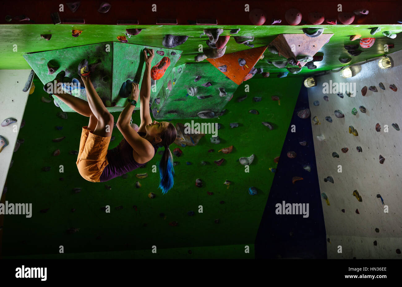 Woman bouldering on climbing gym Stock Photo - Alamy