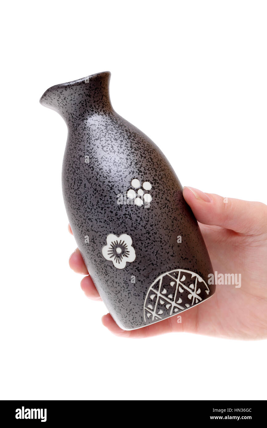 Hand holding japanese sake bottle isolated on white background Stock ...
