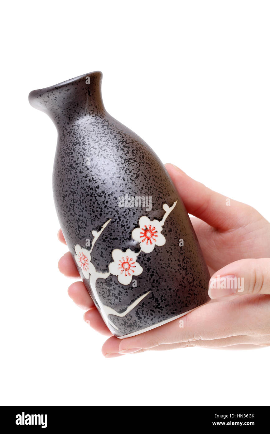 Hand holding japanese sake bottle isolated on white background Stock ...
