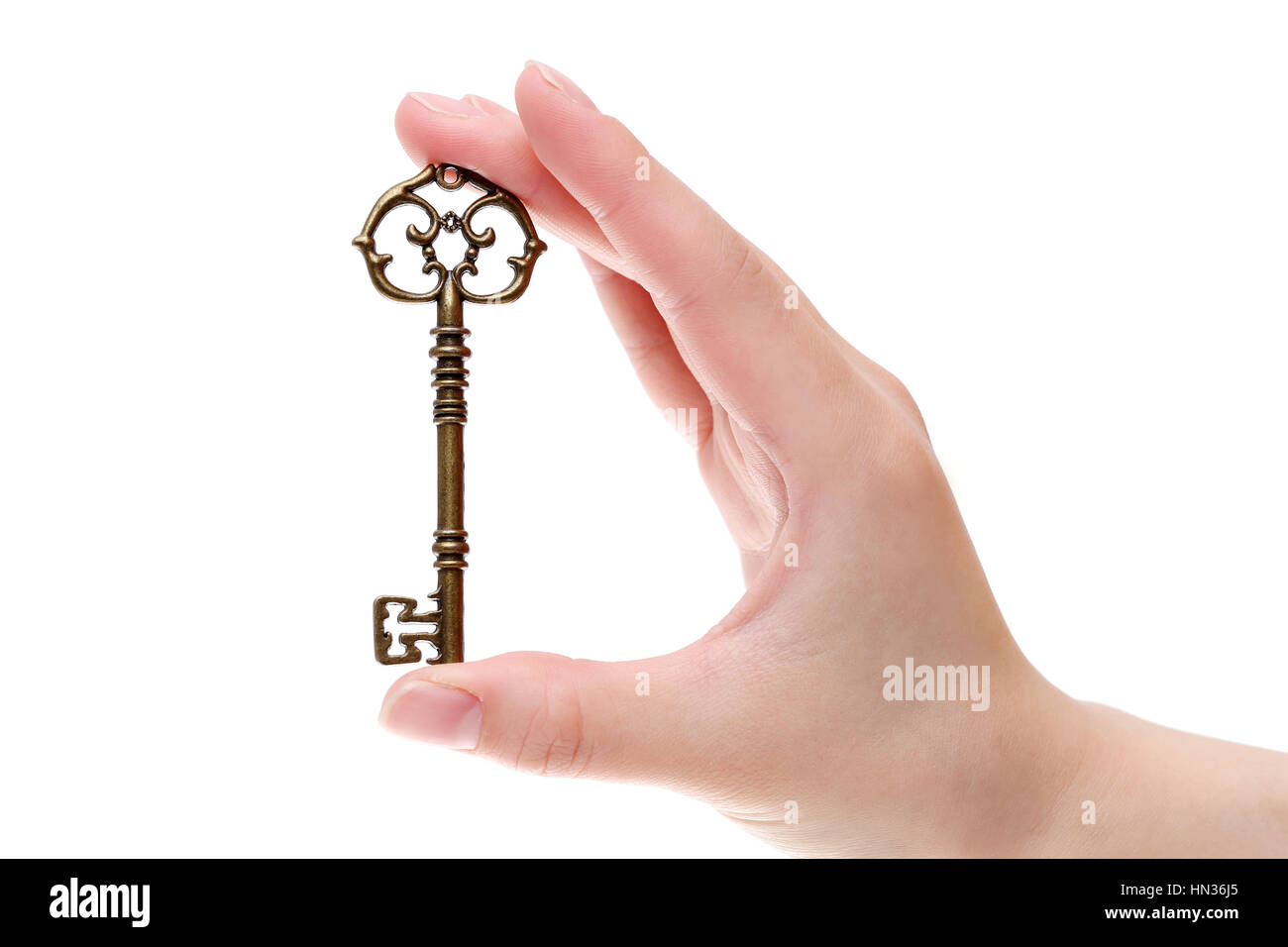 Hand holding antique key isolated on white background Stock Photo - Alamy