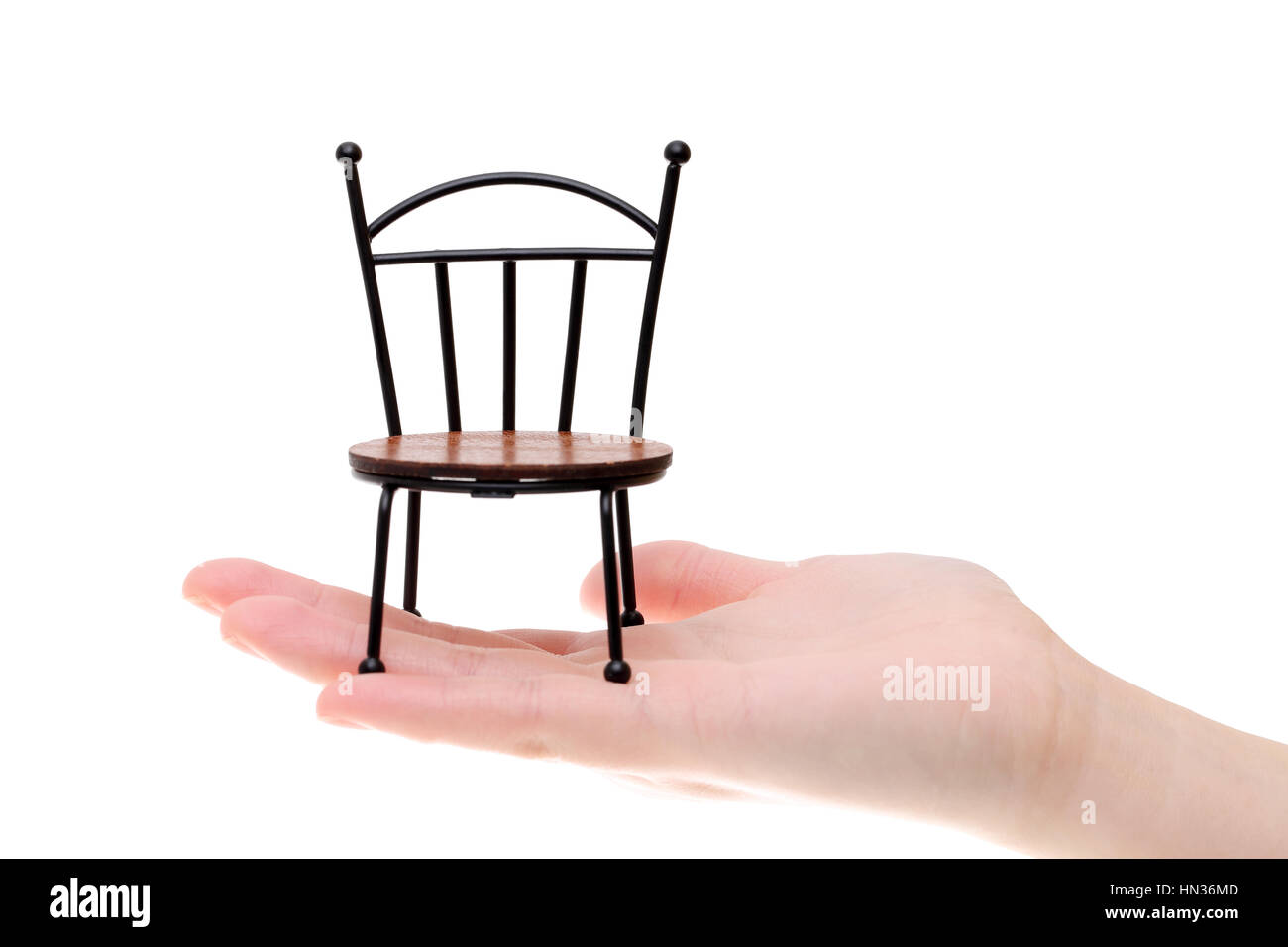 small toy chair on the hand isolated on white background Stock Photo ...