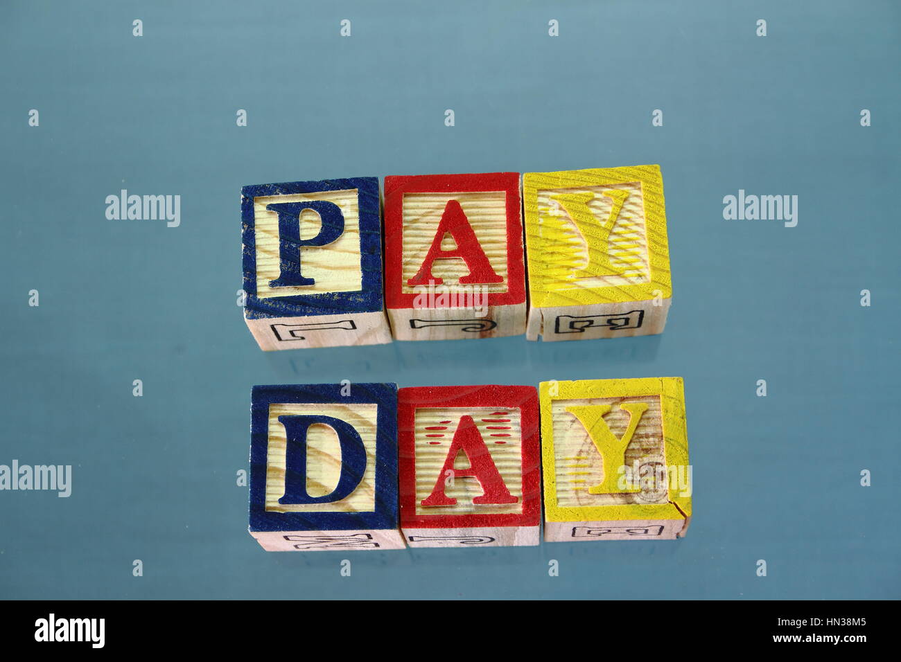 The term pay day displayed on a clear blue background using colorful ...