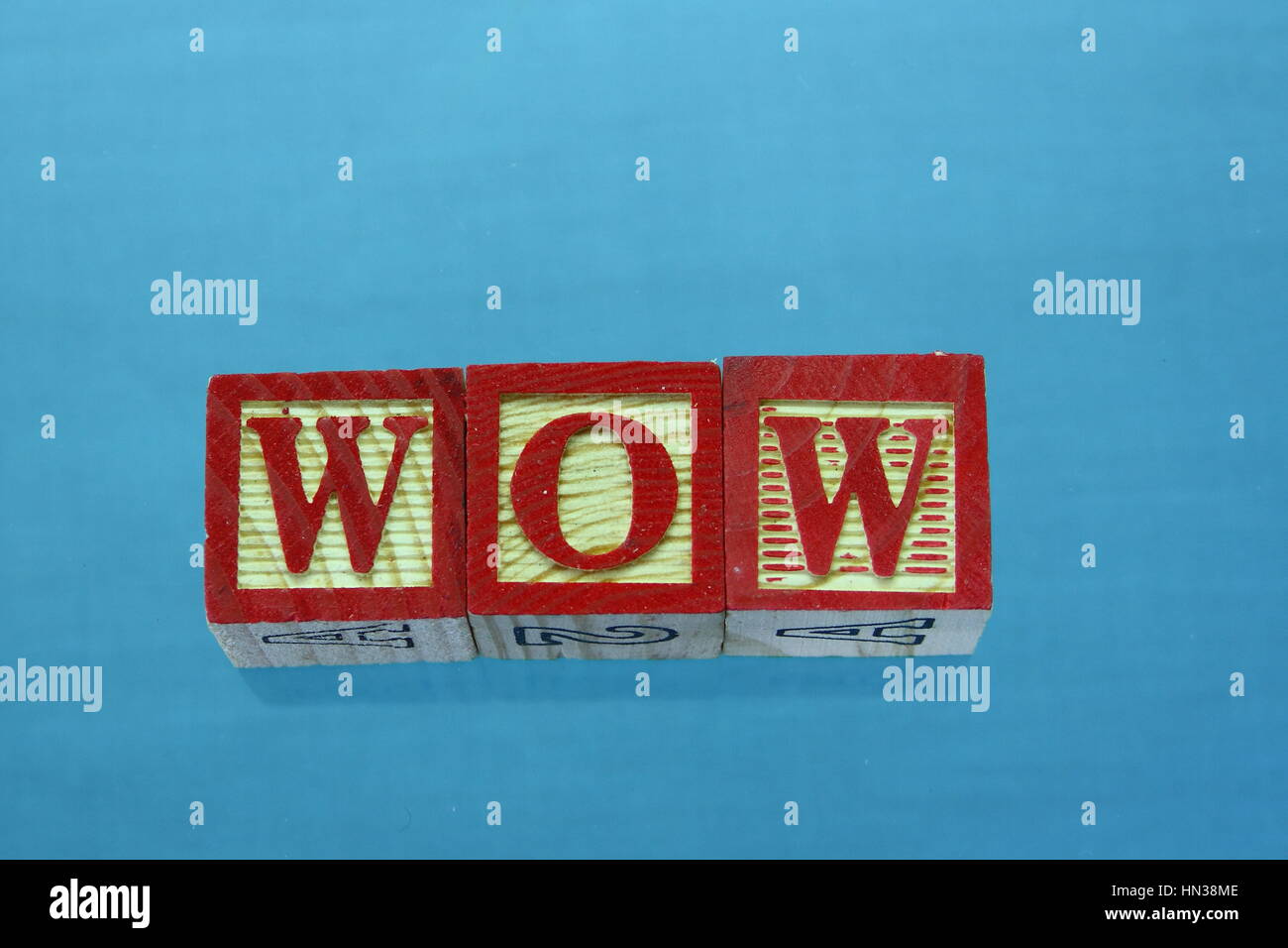 The term wow displayed on a clear blue background using colorful wood ...