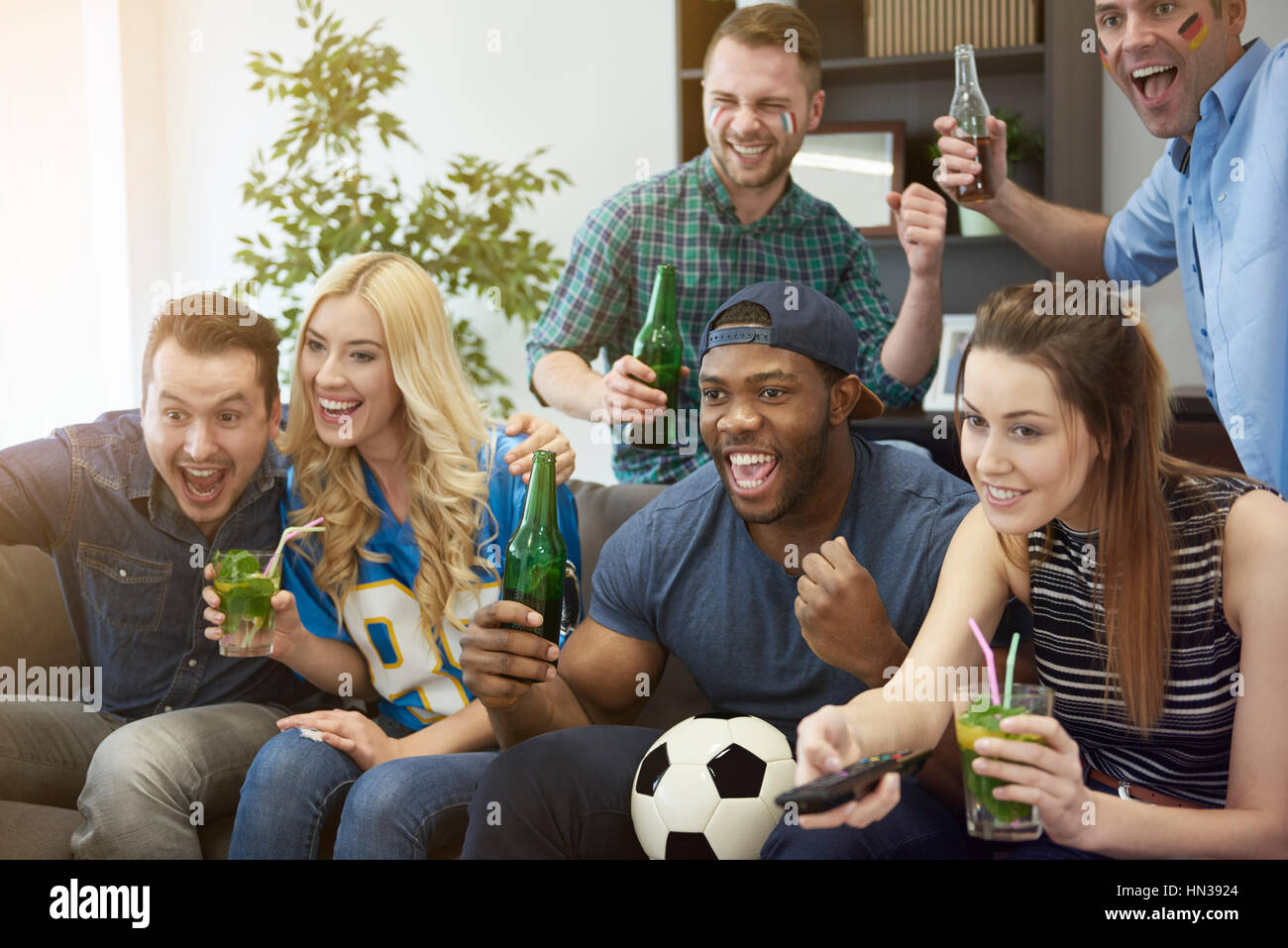 Football fans in the living room Stock Photo - Alamy