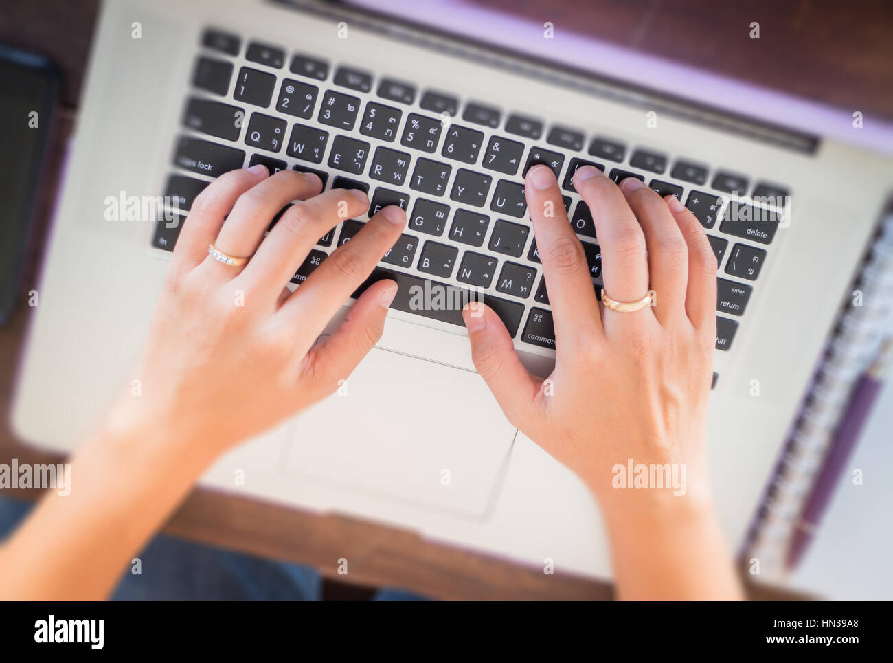 Typing on keyboard laptop top view of wooden table, stock photo Stock ...