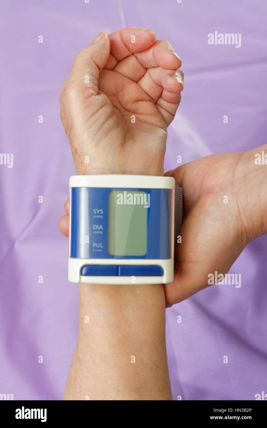 Close-up of blood pressure metering on an aged hand Stock Photo - Alamy