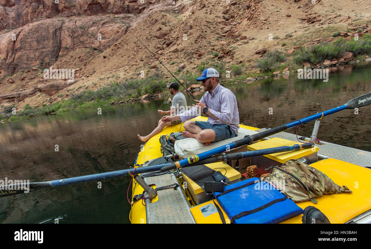 Two Men Fly Fishing From A Raft On The Colorado River In The Grand ...