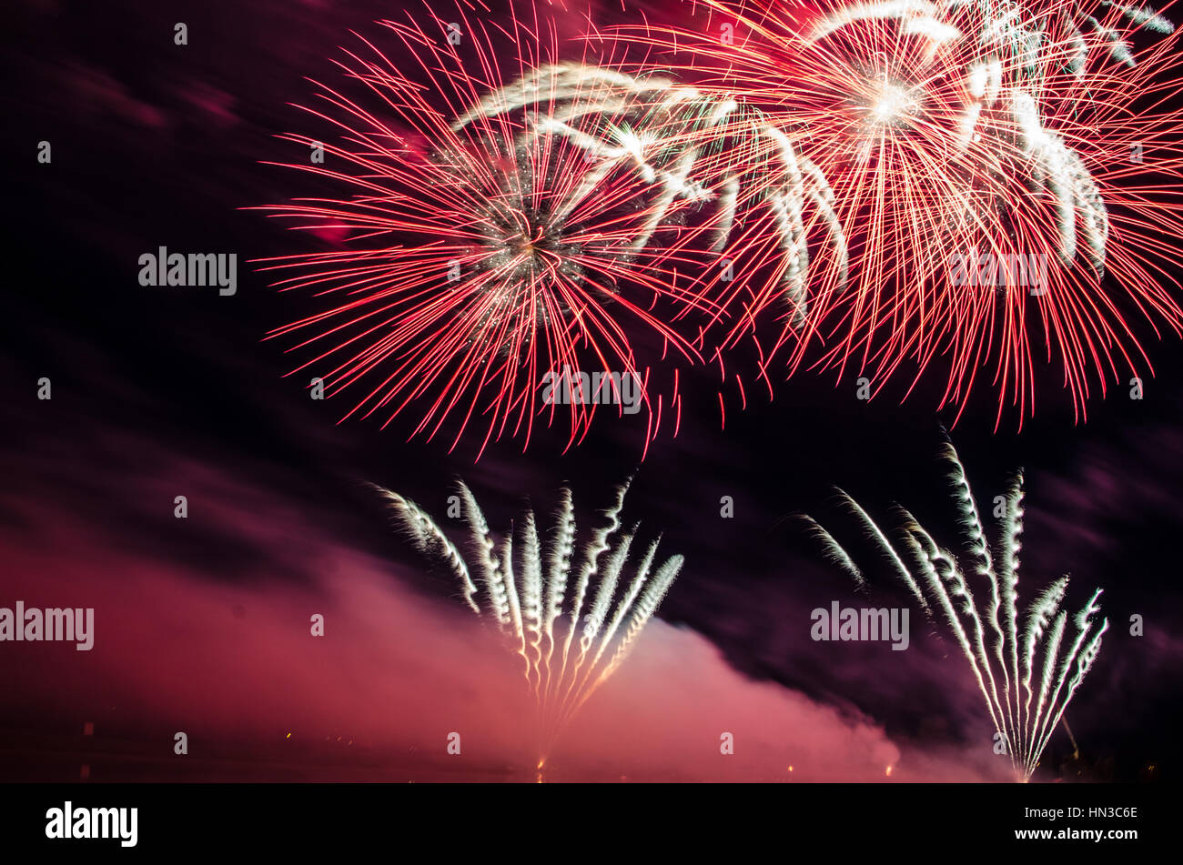 Fireworks display bursts at night Stock Photo - Alamy