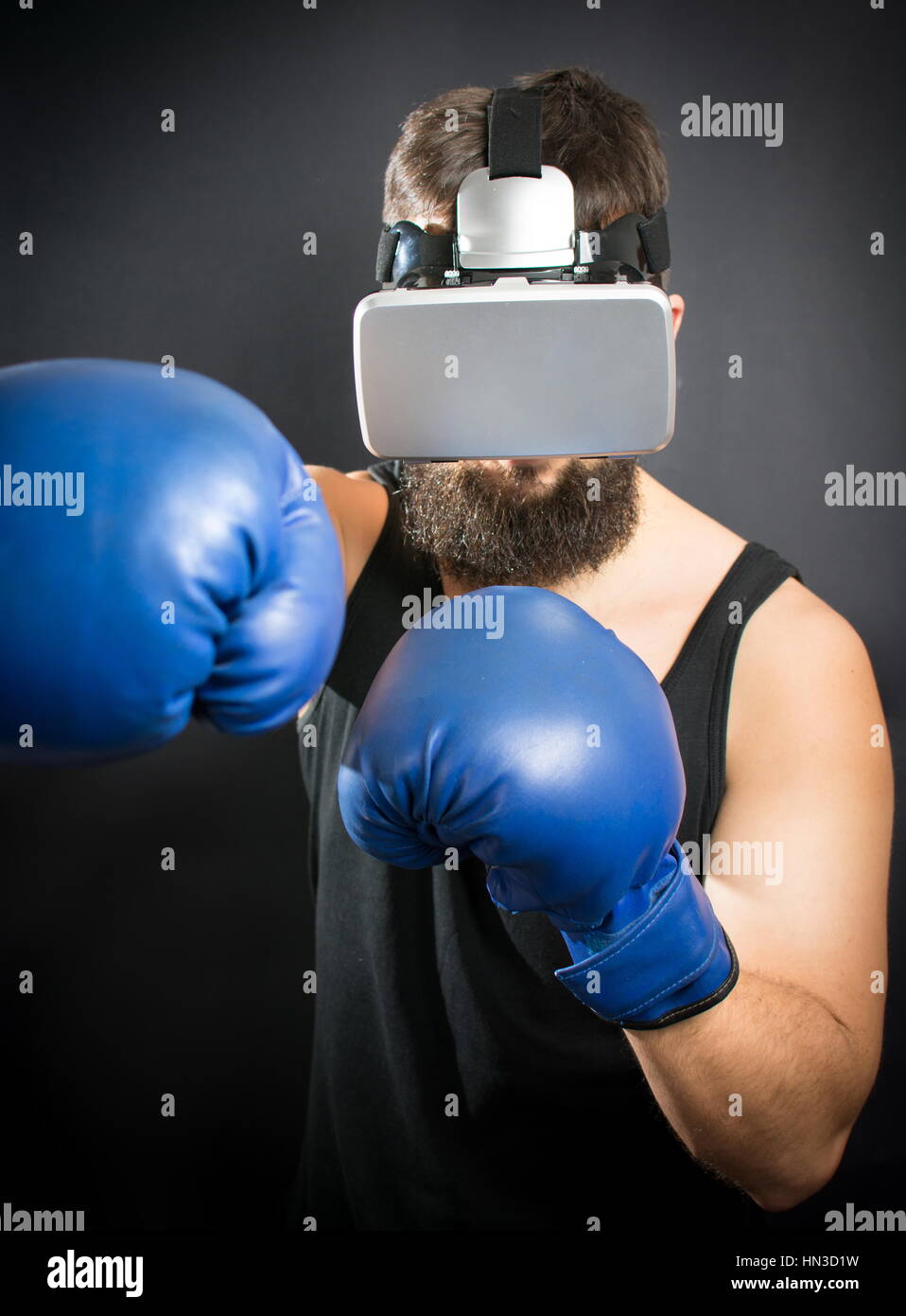 Boxer with VR glasses and blue boxing gloves Stock Photo - Alamy