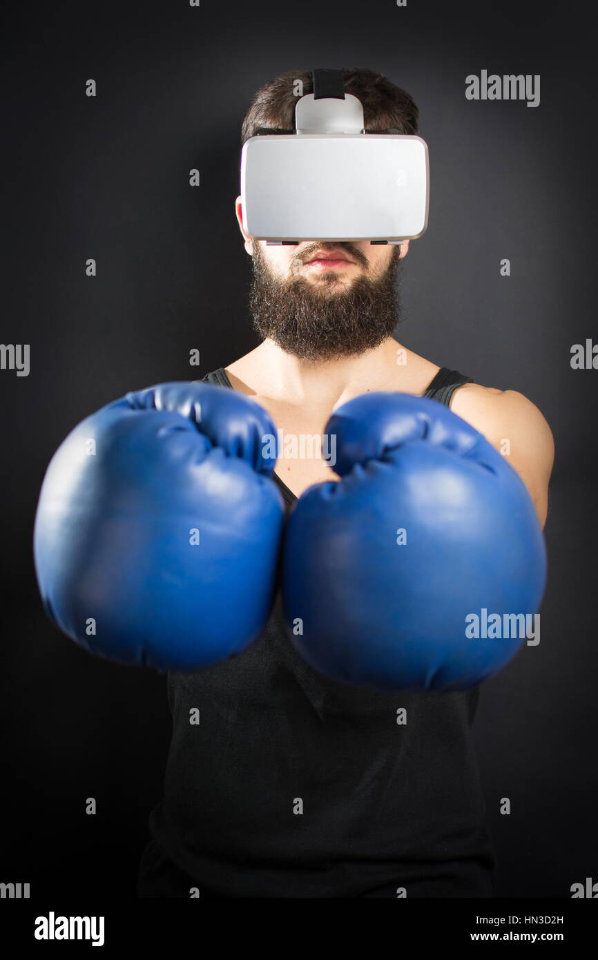 Boxer with VR glasses and blue boxing gloves Stock Photo - Alamy