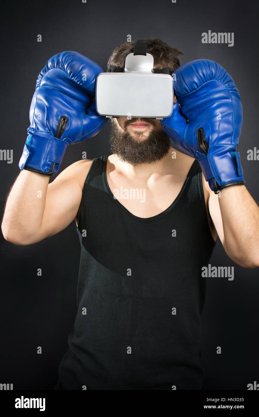 Boxer with VR glasses and blue boxing gloves Stock Photo - Alamy