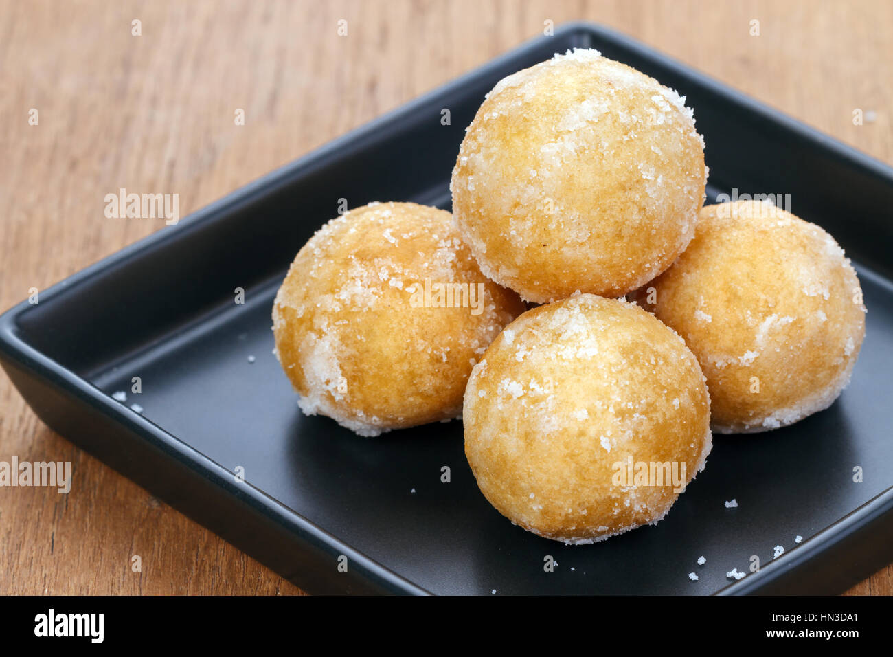 Crisp sweet rice ball made from sticky rice on black plate Stock Photo ...
