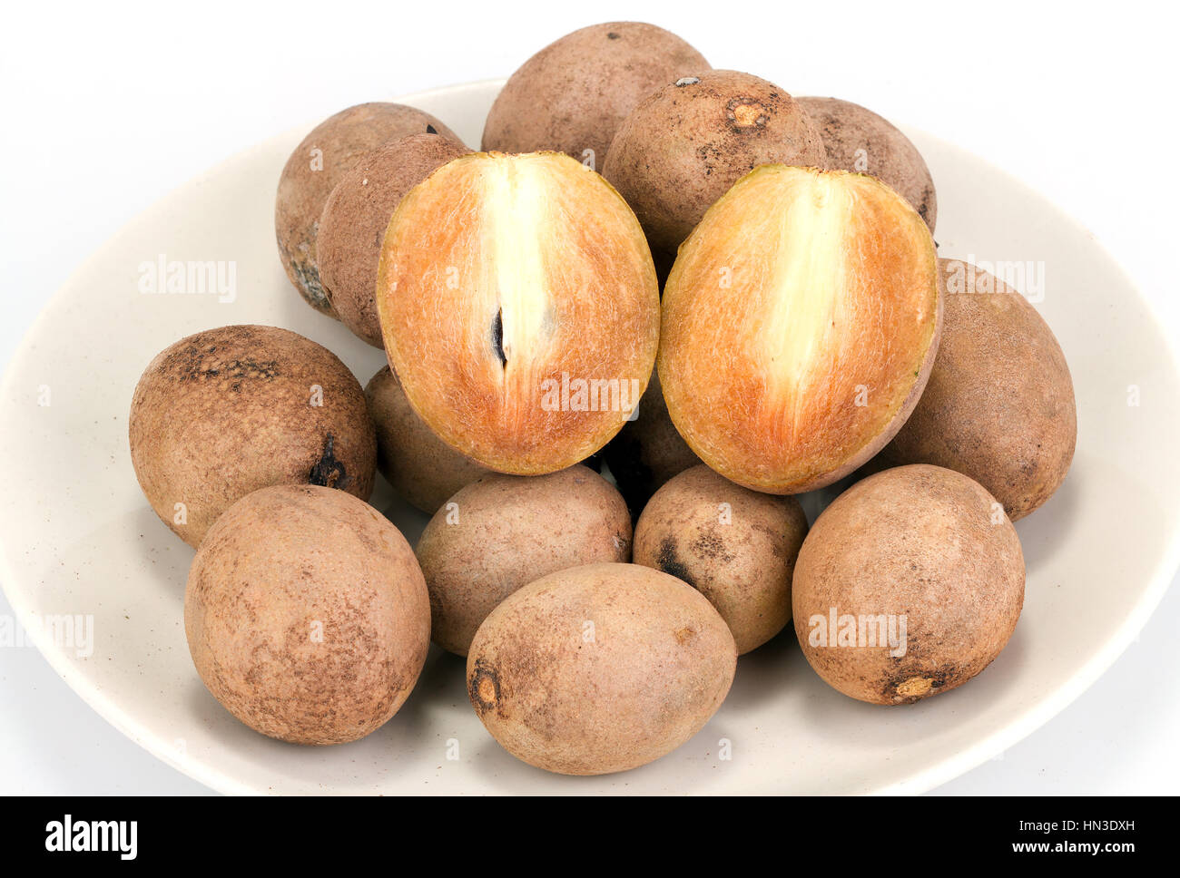 fresh Sapodilla - whole and half cut on white background Stock Photo ...