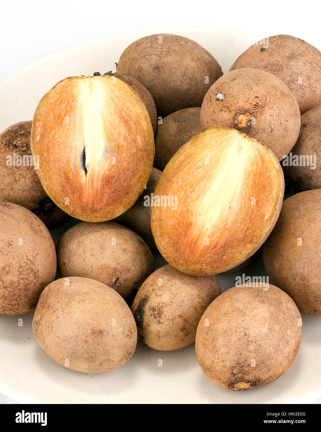 fresh Sapodilla - whole and half cut on white background Stock Photo ...