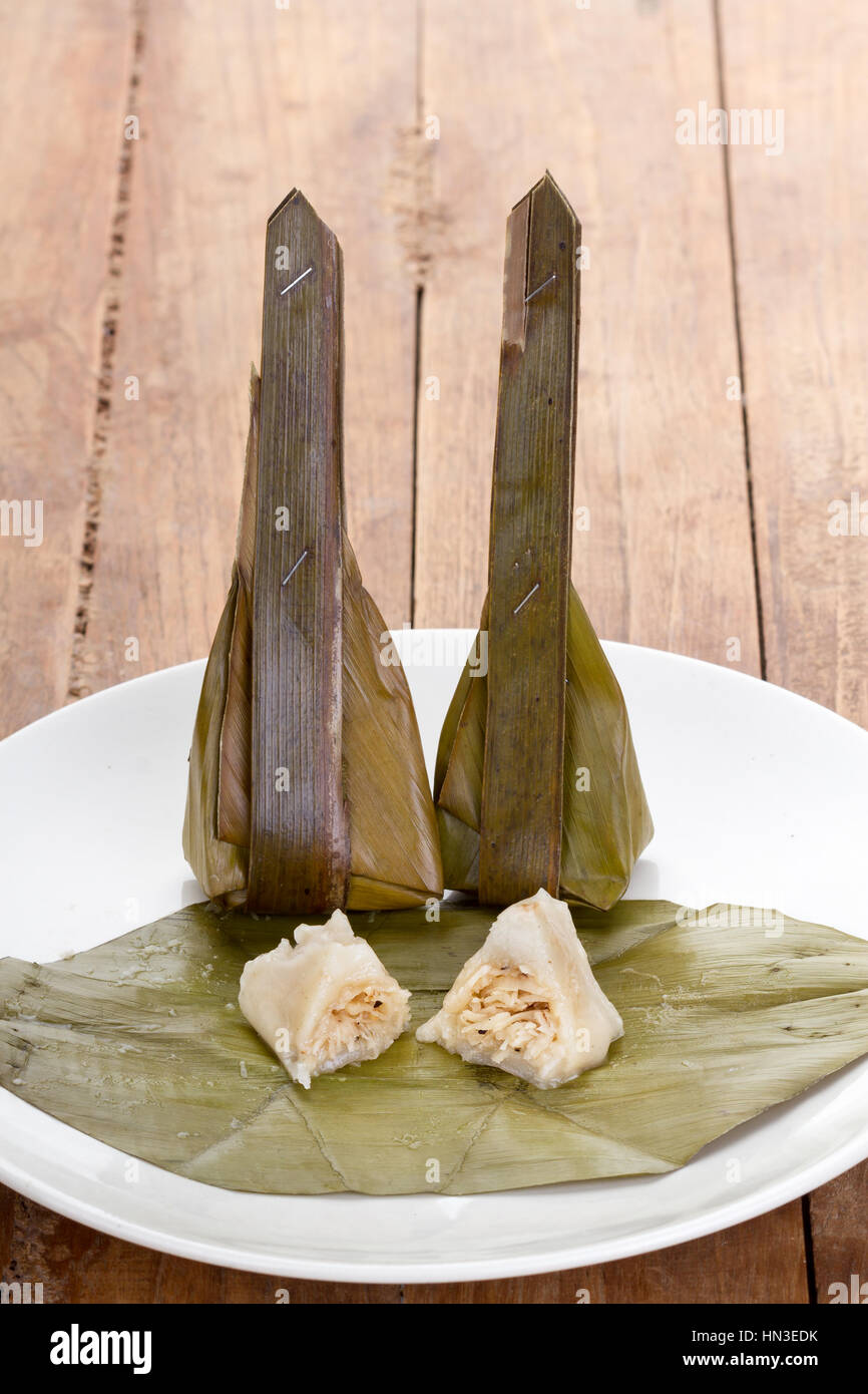 Thai Dessert - Grated Coconut Pudding wrapped by banana leaf - cooked ...