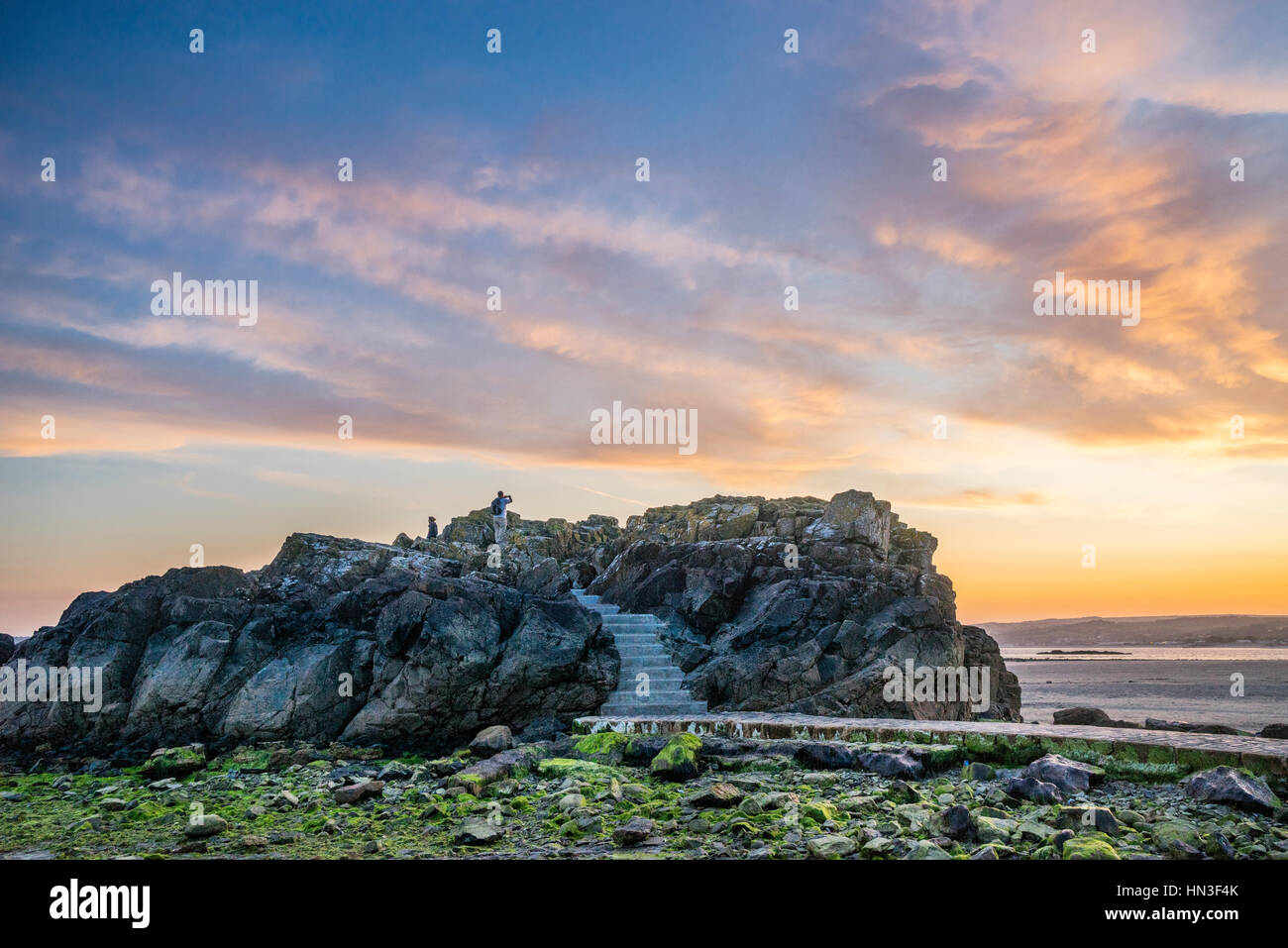 United Kingdom, Cornwall, Marazion, a rock outcrop is exposed during ...