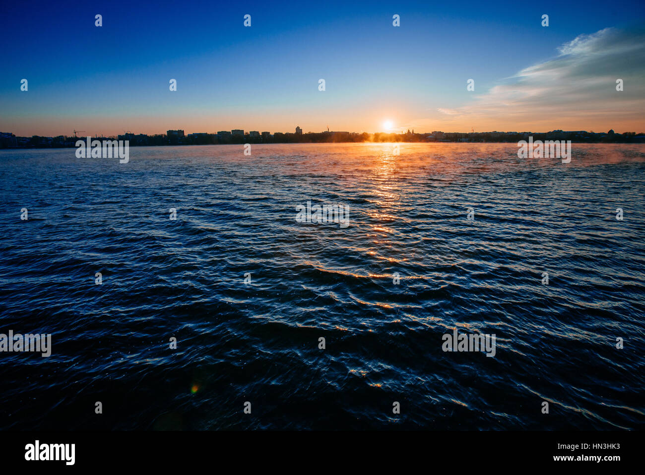 Sunset over the water Stock Photo - Alamy