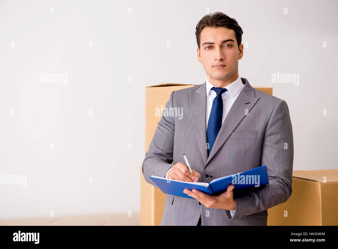 Man signing for the delivery of boxes Stock Photo - Alamy
