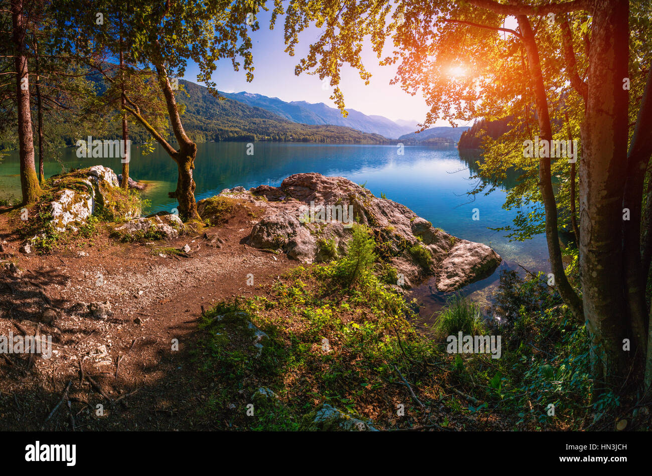 Mountain lake between by mountains Stock Photo - Alamy
