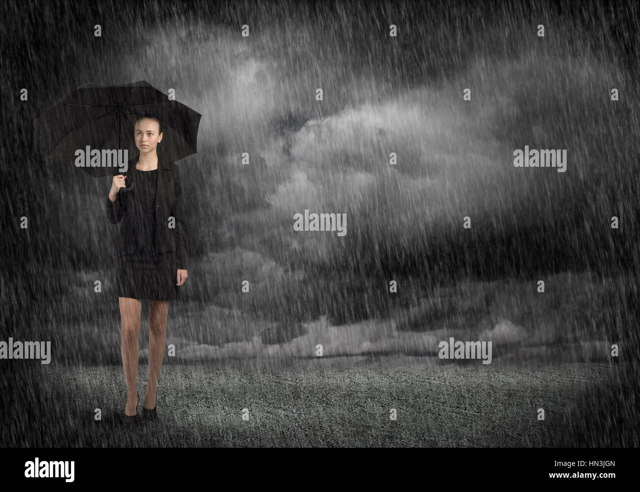 Young businesswoman with umbrella standing in rain Stock Photo - Alamy