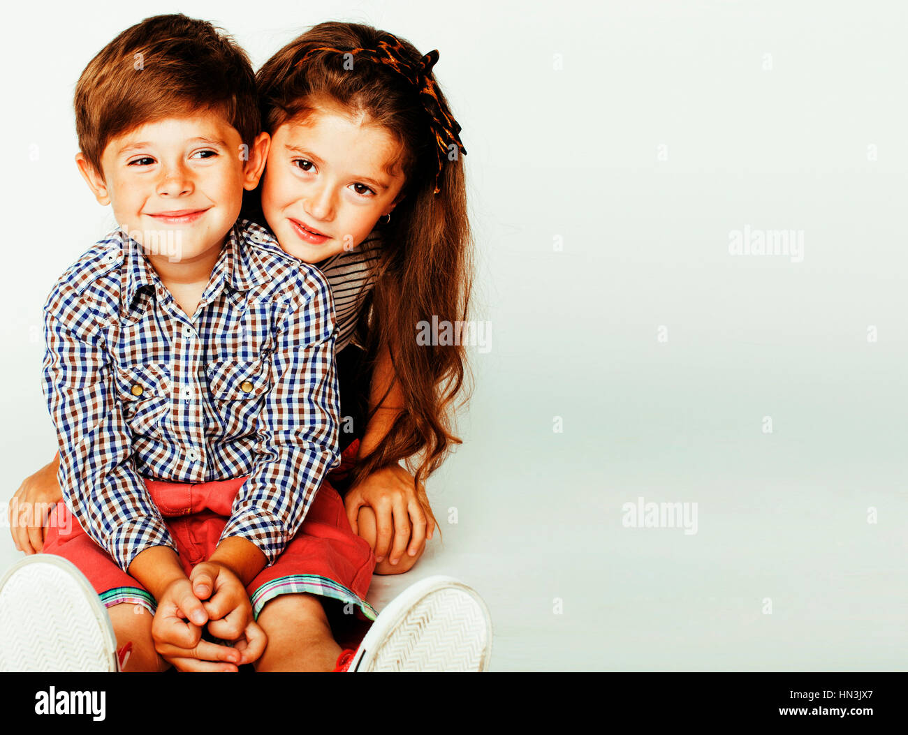 little cute boy and girl hugging playing on white background, ha Stock Photo - Alamy