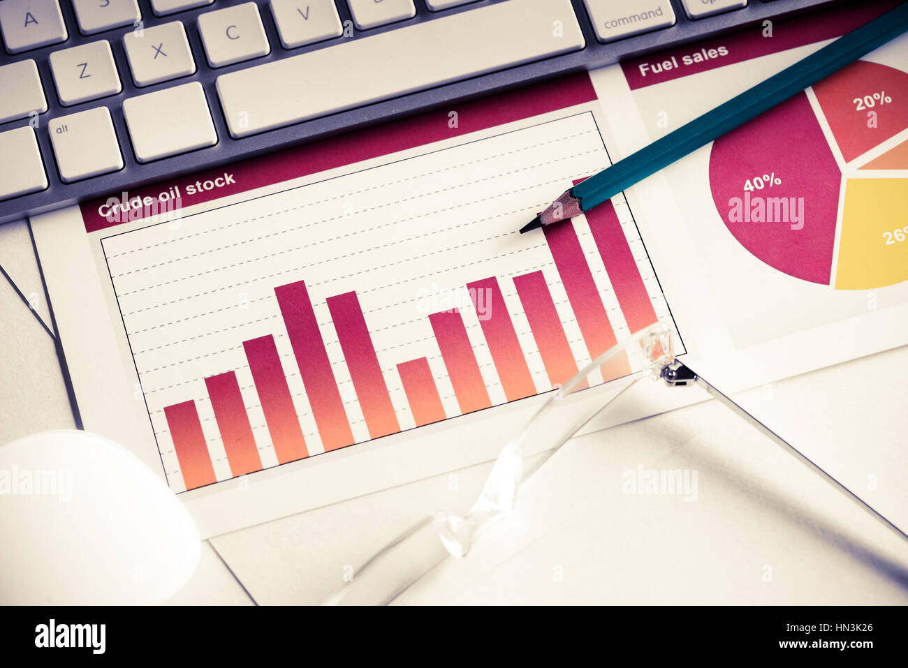 Business workplace with keyboard mouse and papers with graphs and ...