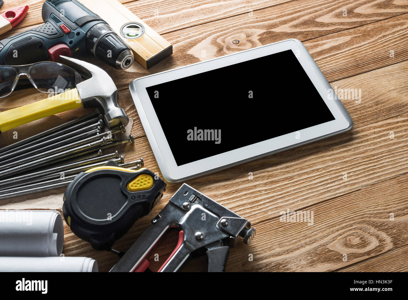Variety of tools of builder and tablet pc on wooden texture table Stock ...