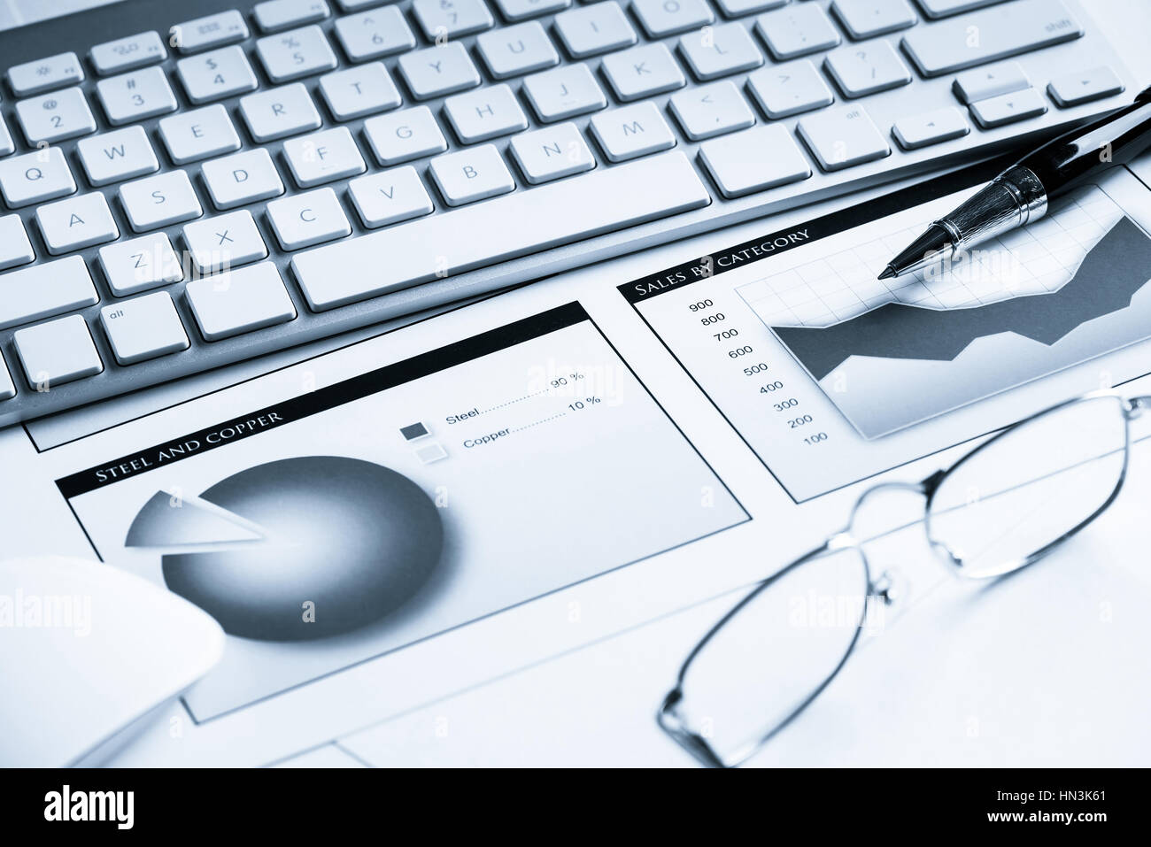 Business workplace with keyboard mouse and papers with graphs and ...