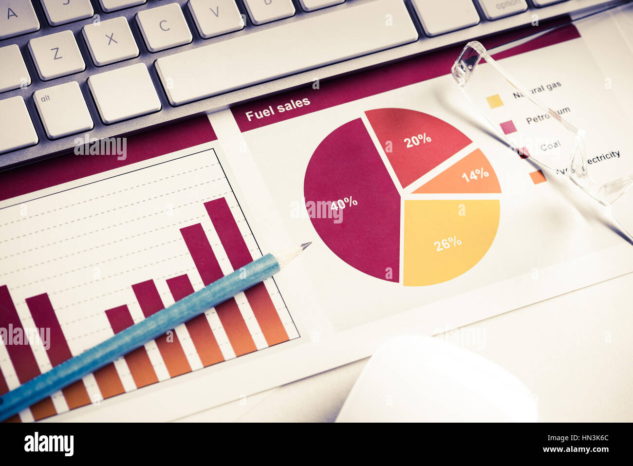 Business workplace with keyboard mouse and papers with graphs and ...