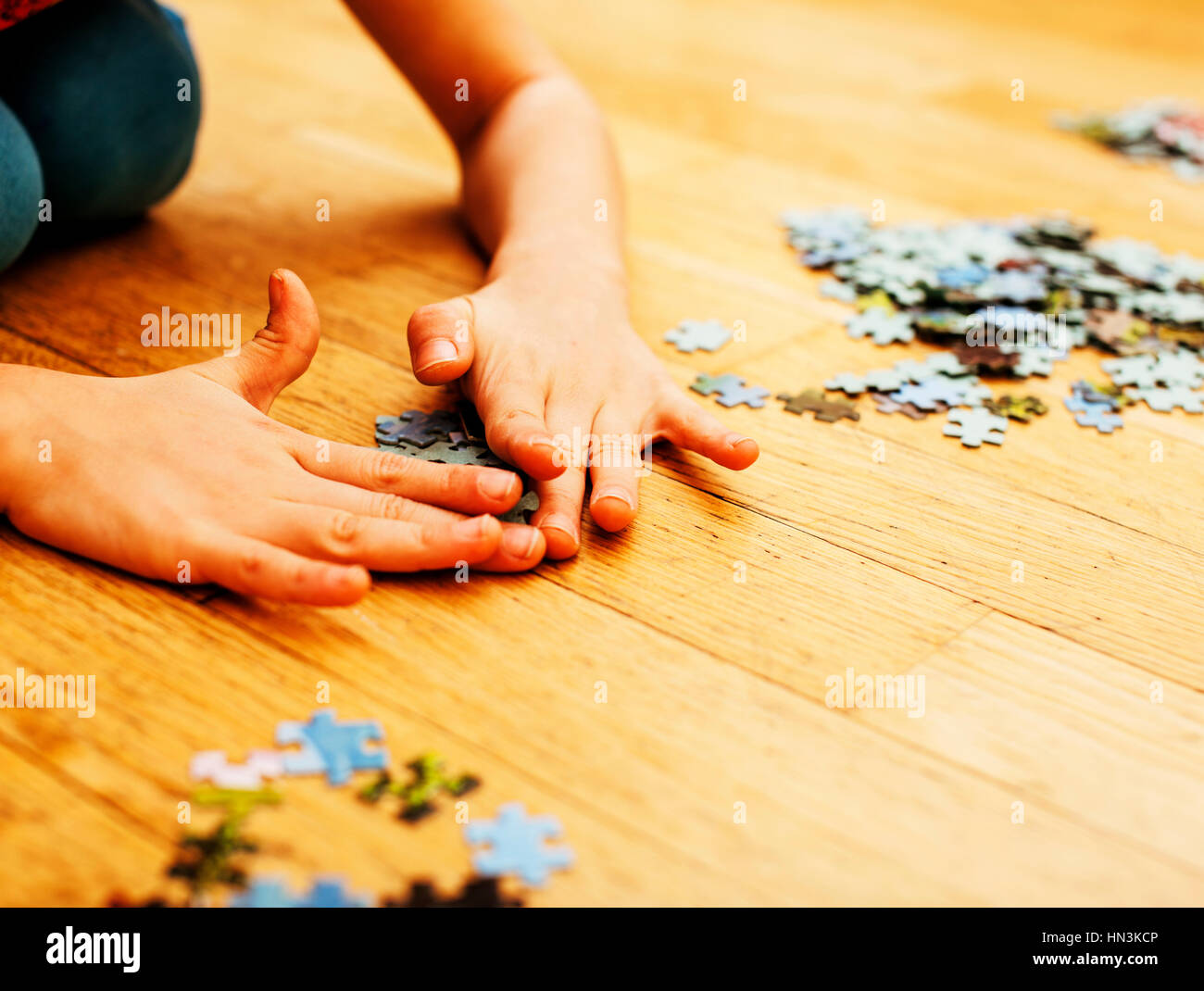 Children doing jigsaw puzzle together hi-res stock photography and ...