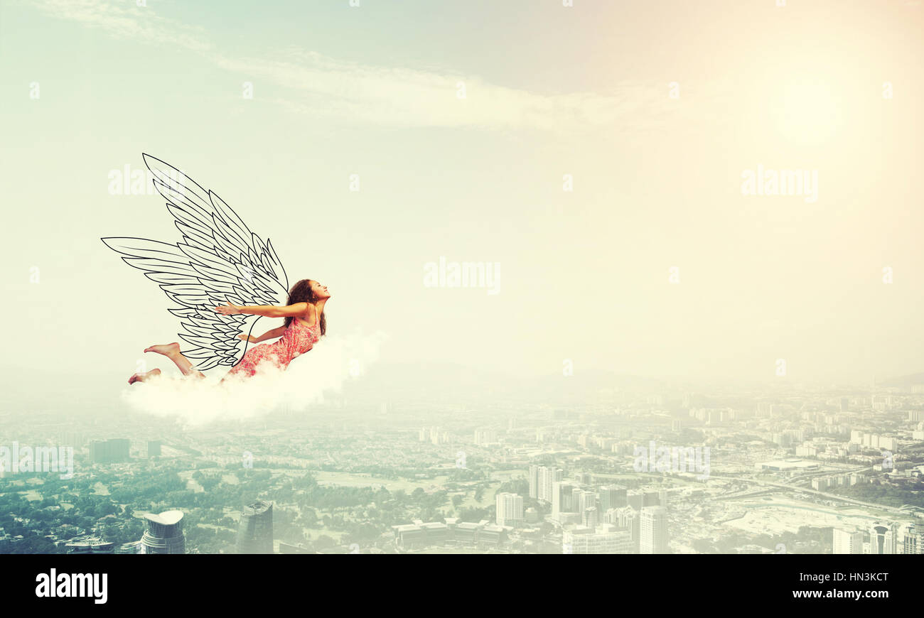 Young woman flying high in blue sky Stock Photo - Alamy