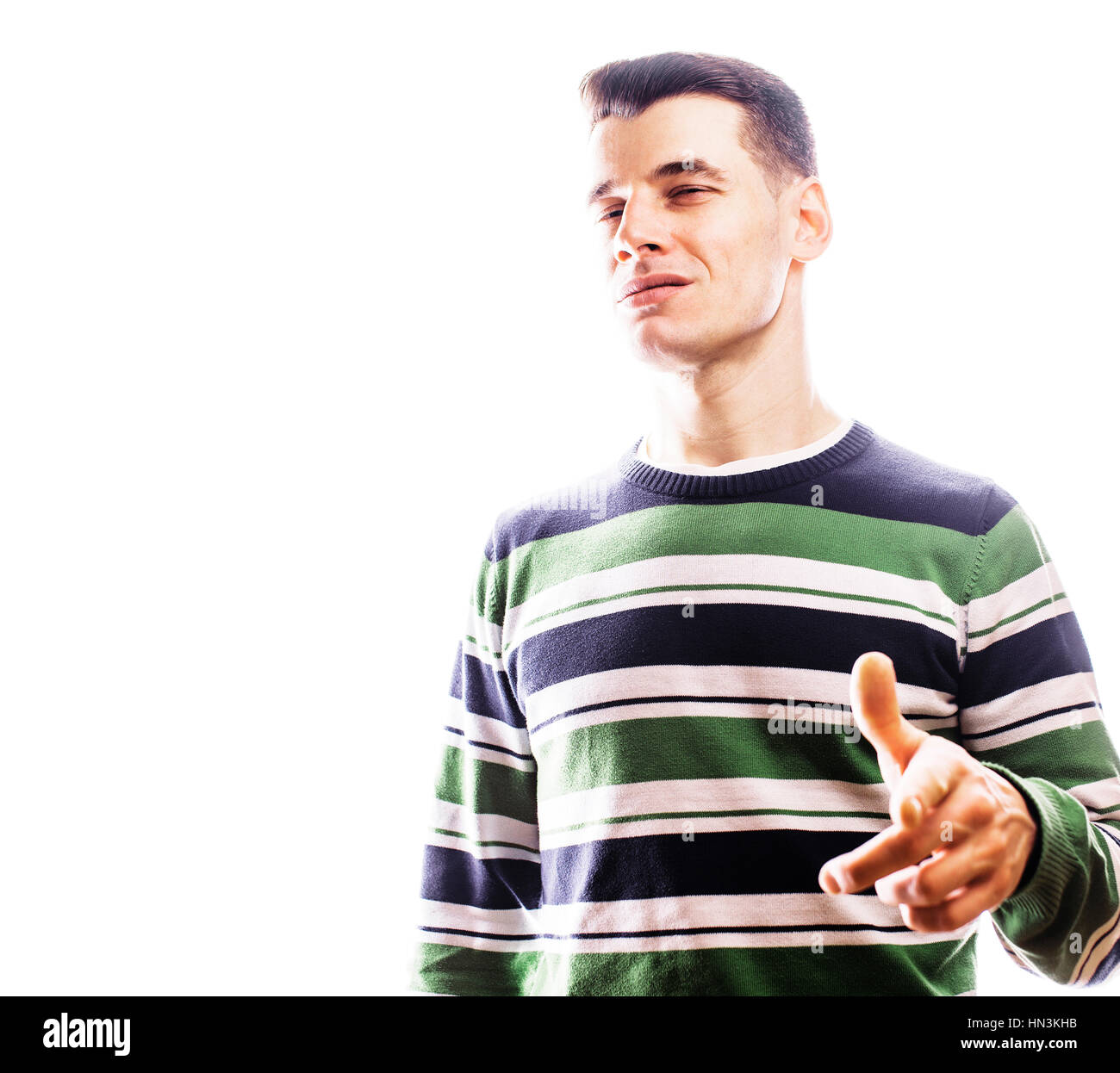Portrait of a smart serious young man standing against white bac Stock ...