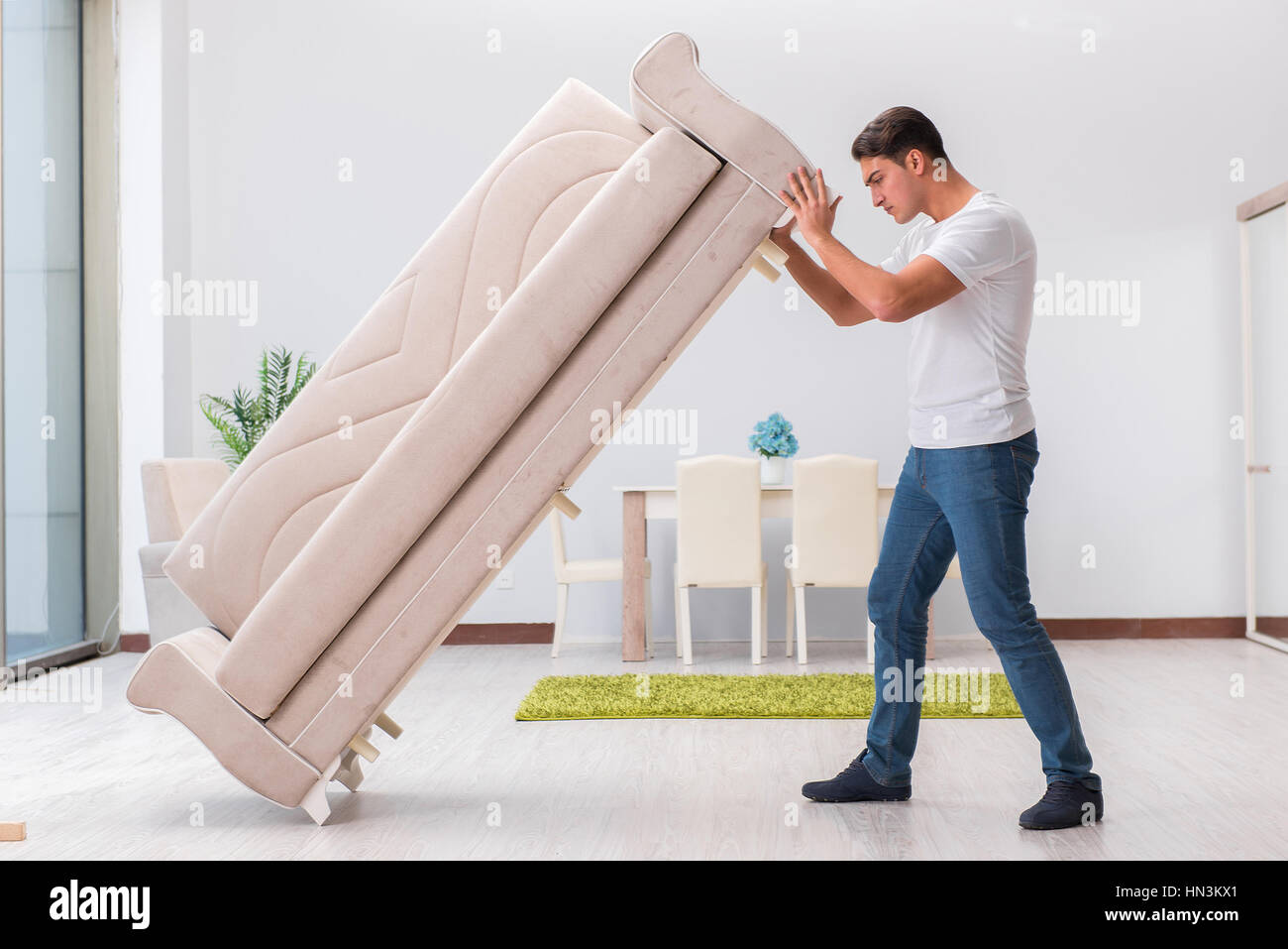 Man moving furniture at home Stock Photo - Alamy