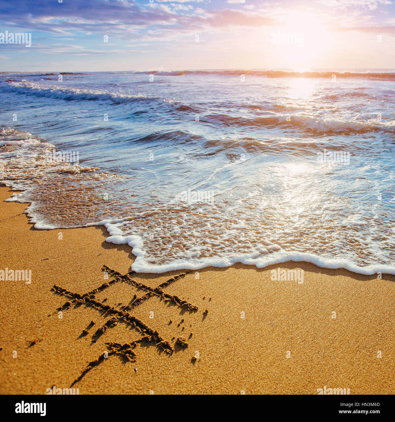Sunset on the sandy beach Stock Photo - Alamy