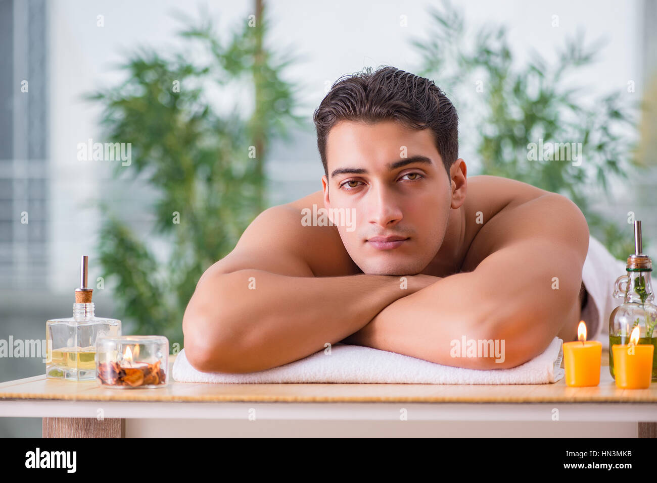 Handsome man during spa massaging session Stock Photo - Alamy