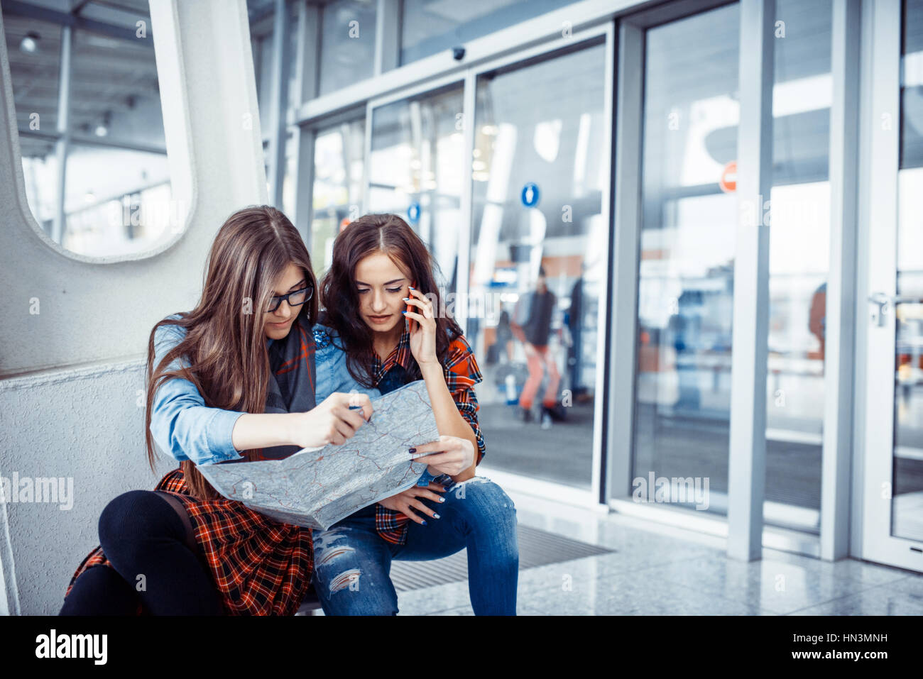 Two girlfriends looking for a route map.Art processing and retou Stock ...