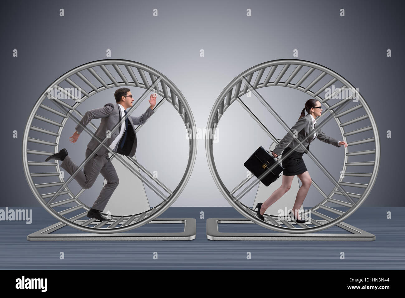 Business concept with pair running on hamster wheel Stock Photo - Alamy