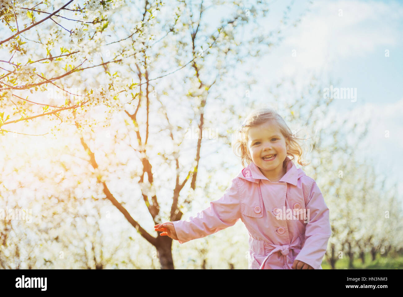 Child running outdoors blossom trees Stock Photo - Alamy