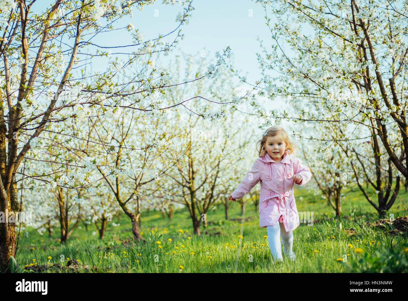 child running outdoors blossom trees. Art processing and retouch Stock ...