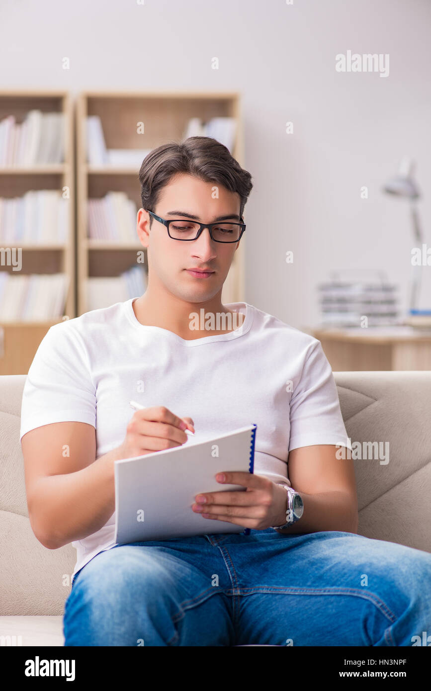 Man working sitting in couch sofa Stock Photo - Alamy