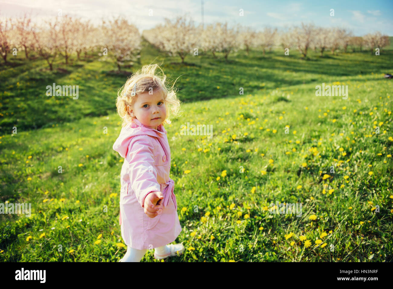 child plays on spring lawn Stock Photo - Alamy