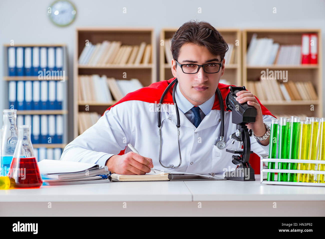Superhero doctor working in the hospital lab Stock Photo - Alamy