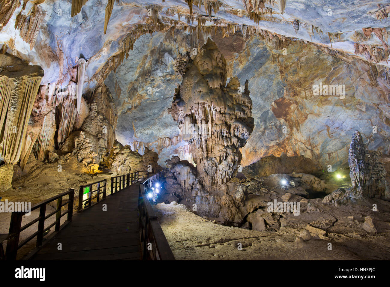 Boardwalk through illuminated dripstone cave, stalactites and ...