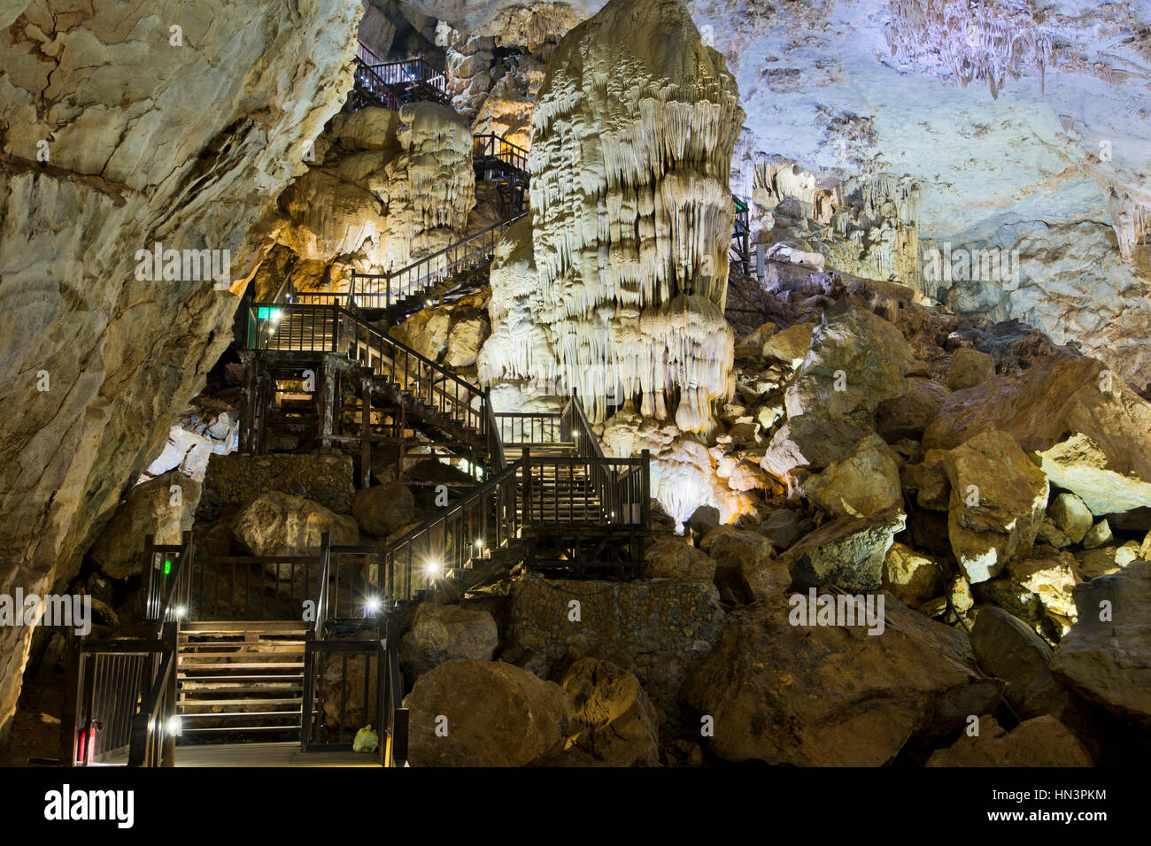 Boardwalk through illuminated dripstone cave, stalactites and ...