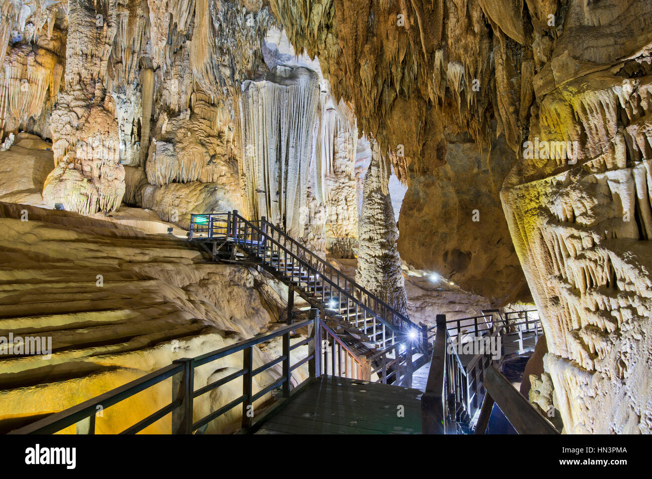 Boardwalk through illuminated dripstone cave, stalactites and ...