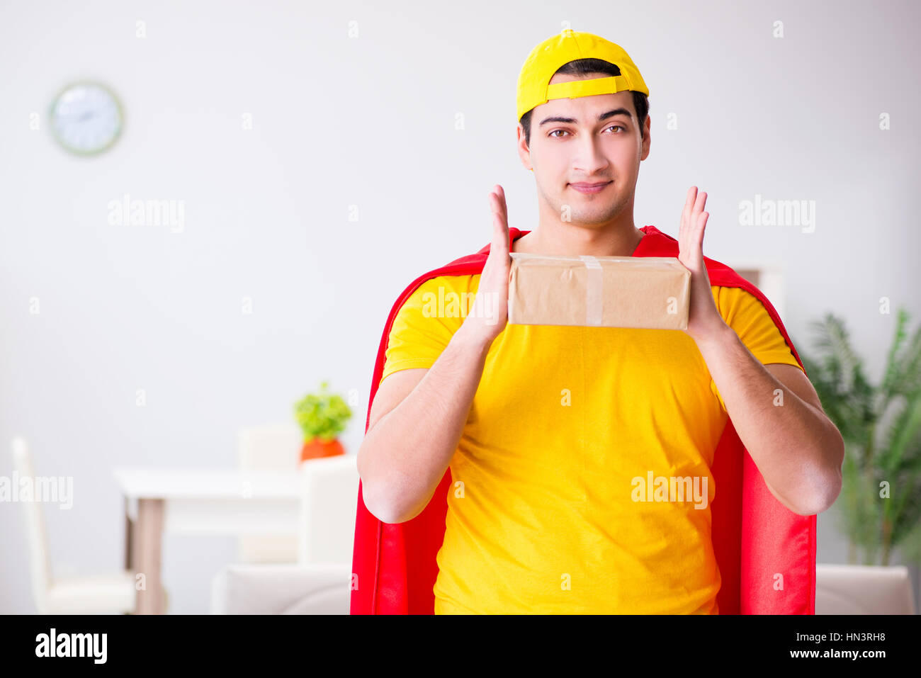 Superhero delivery guy with box Stock Photo - Alamy