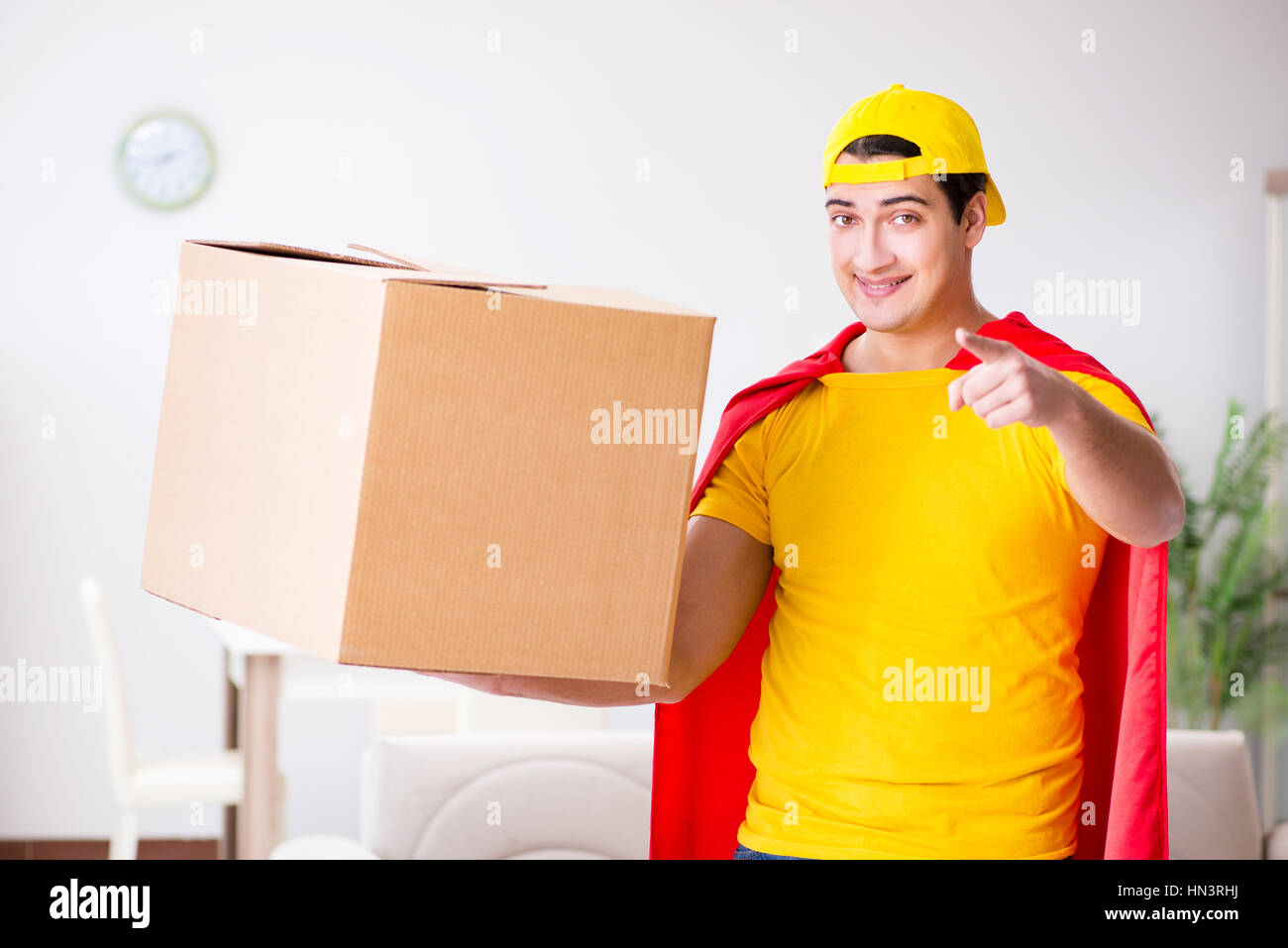 Superhero delivery guy with box Stock Photo - Alamy