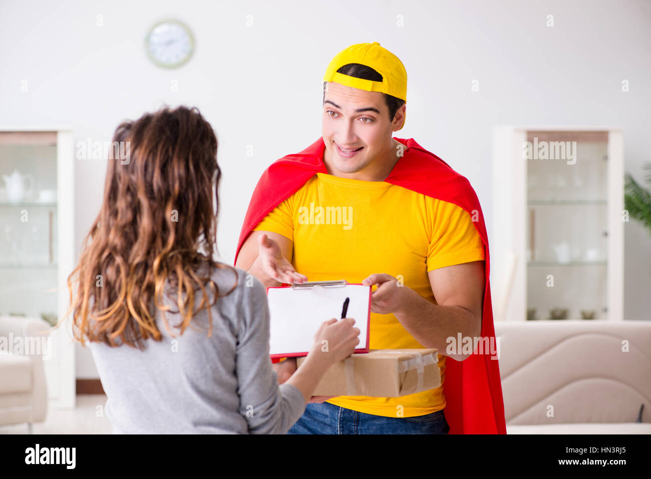 Superhero delivery guy with box Stock Photo - Alamy