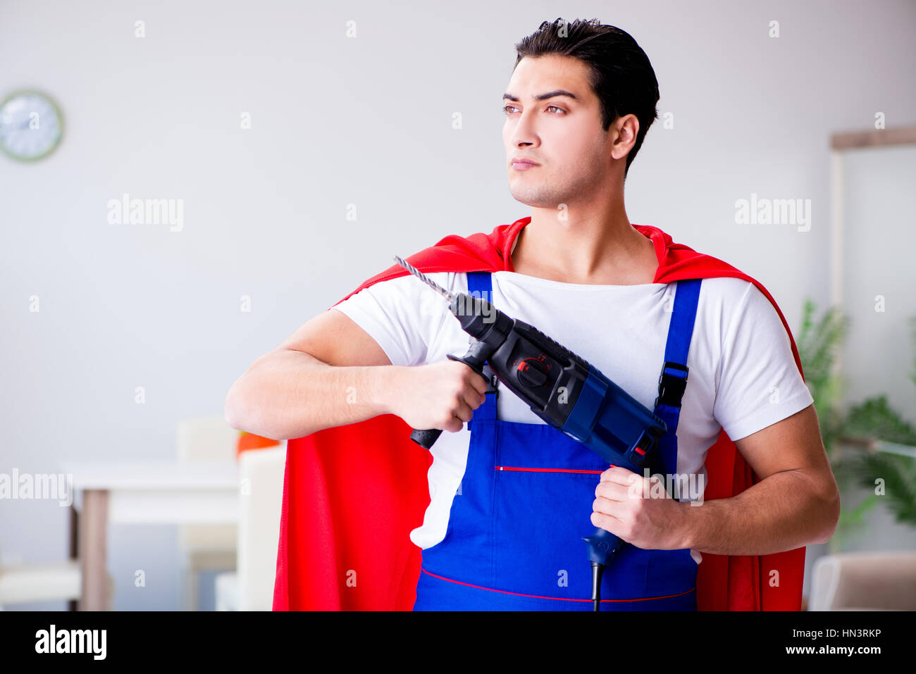 Superhero repairman with tools in repair concept Stock Photo - Alamy